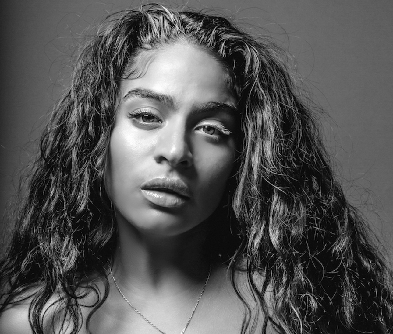 Jessie Reyez announces debut album with new ballad “Love In The Dark”